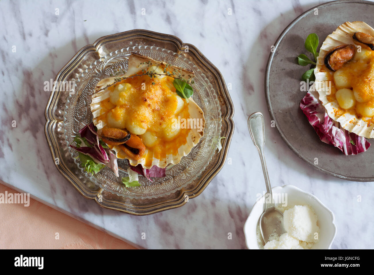 Gnocchi pasta with mussels, tomato and cream room, in vieira shell ...