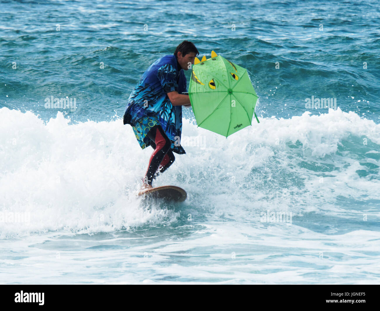 Surfing fun fancy dress surfers Stock Photo - Alamy