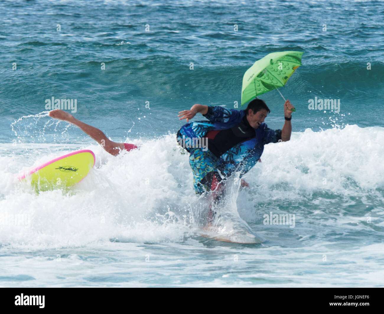 Surfing fun fancy dress surfers Stock Photo - Alamy