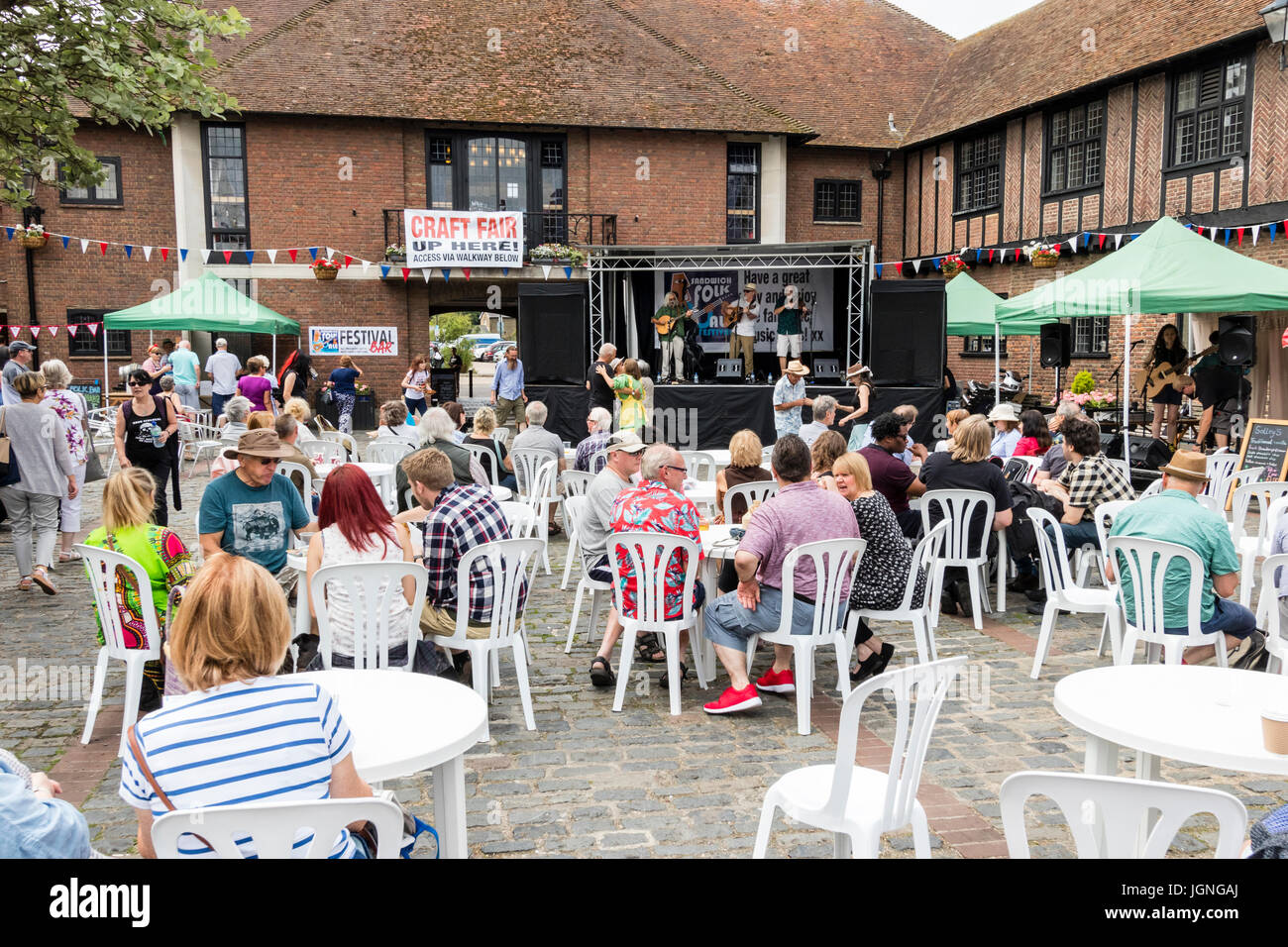Folk and Ale Festival event at Sandwich in Kent. People sitting at ...