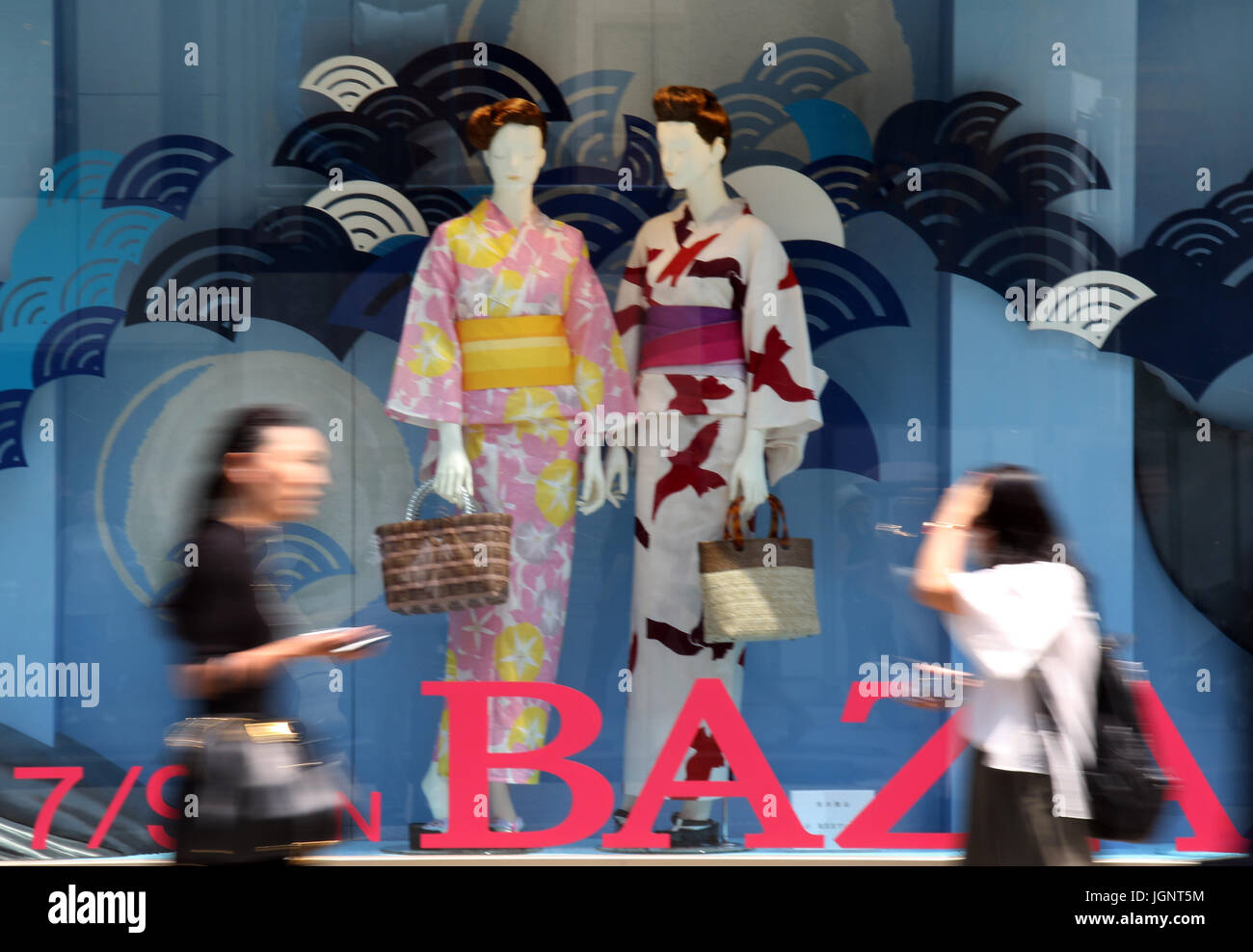 Tokyo, Japan. 9th July, 2017. Pedestrians pass before a large show ...