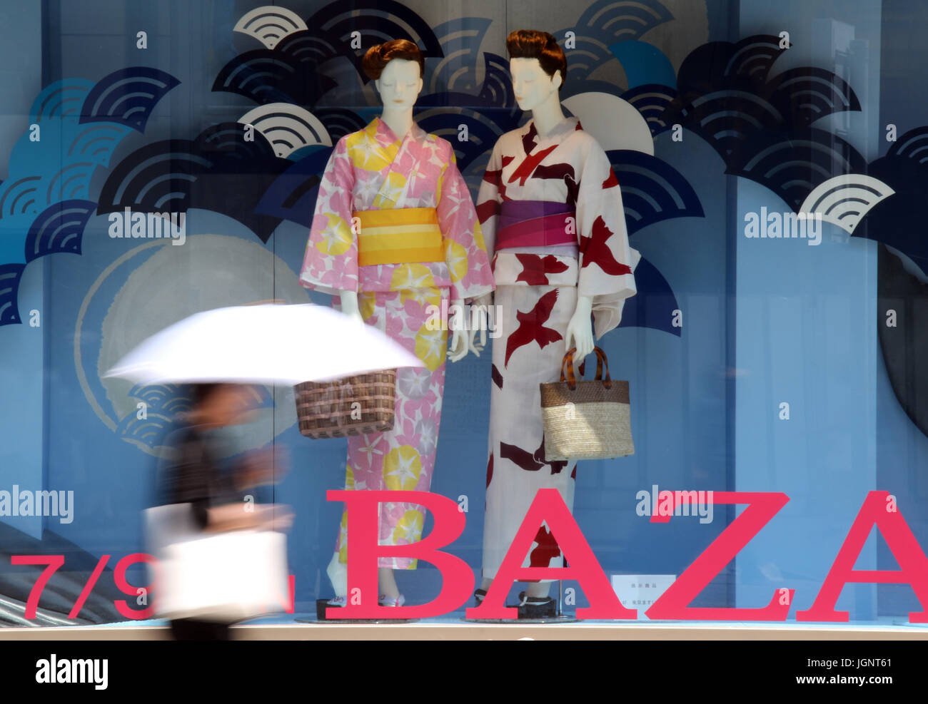Tokyo, Japan. 9th July, 2017. A pedestrian passes a large show window ...