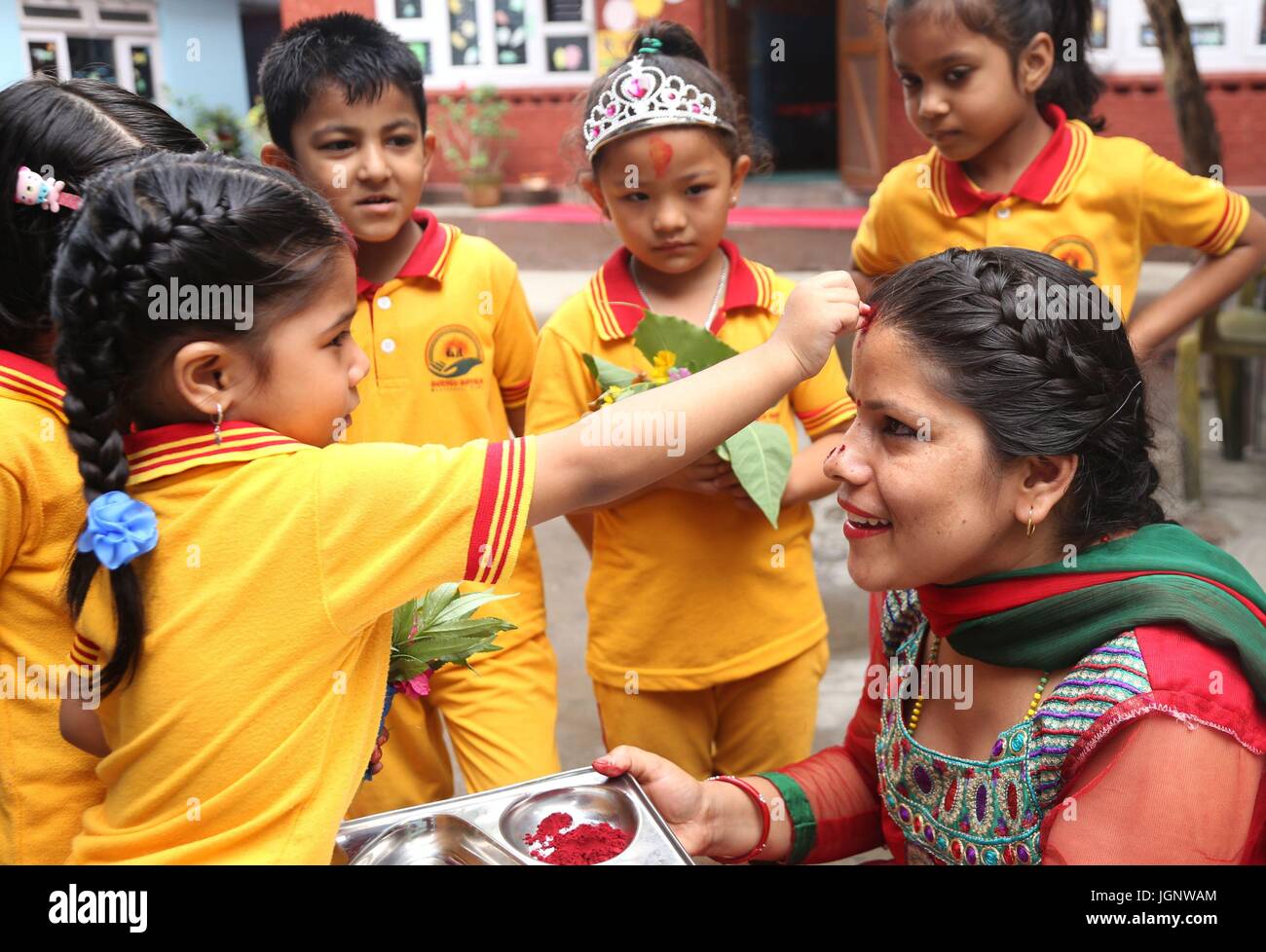(170709) -- KATHMANDU, July 9, 2017 (Xinhua) -- A school child offers ...