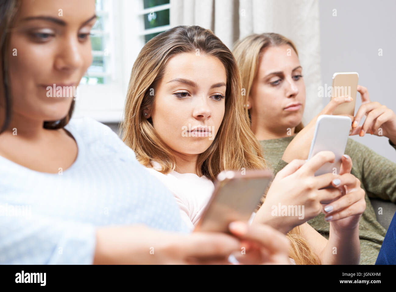 Women using mobile phones ignoring High Resolution Stock Photography ...
