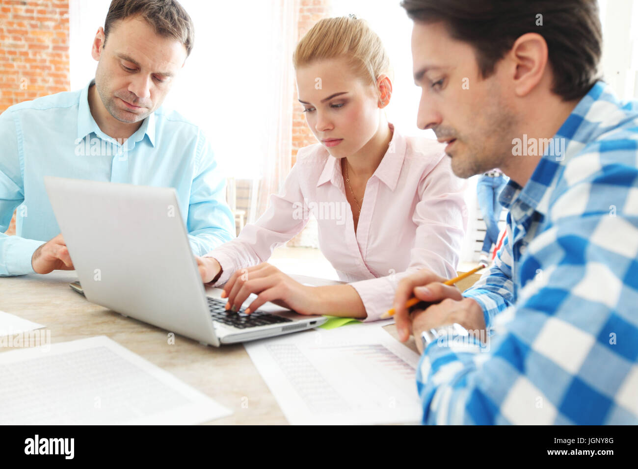 Business team work together looking at one laptop at workplace Stock ...