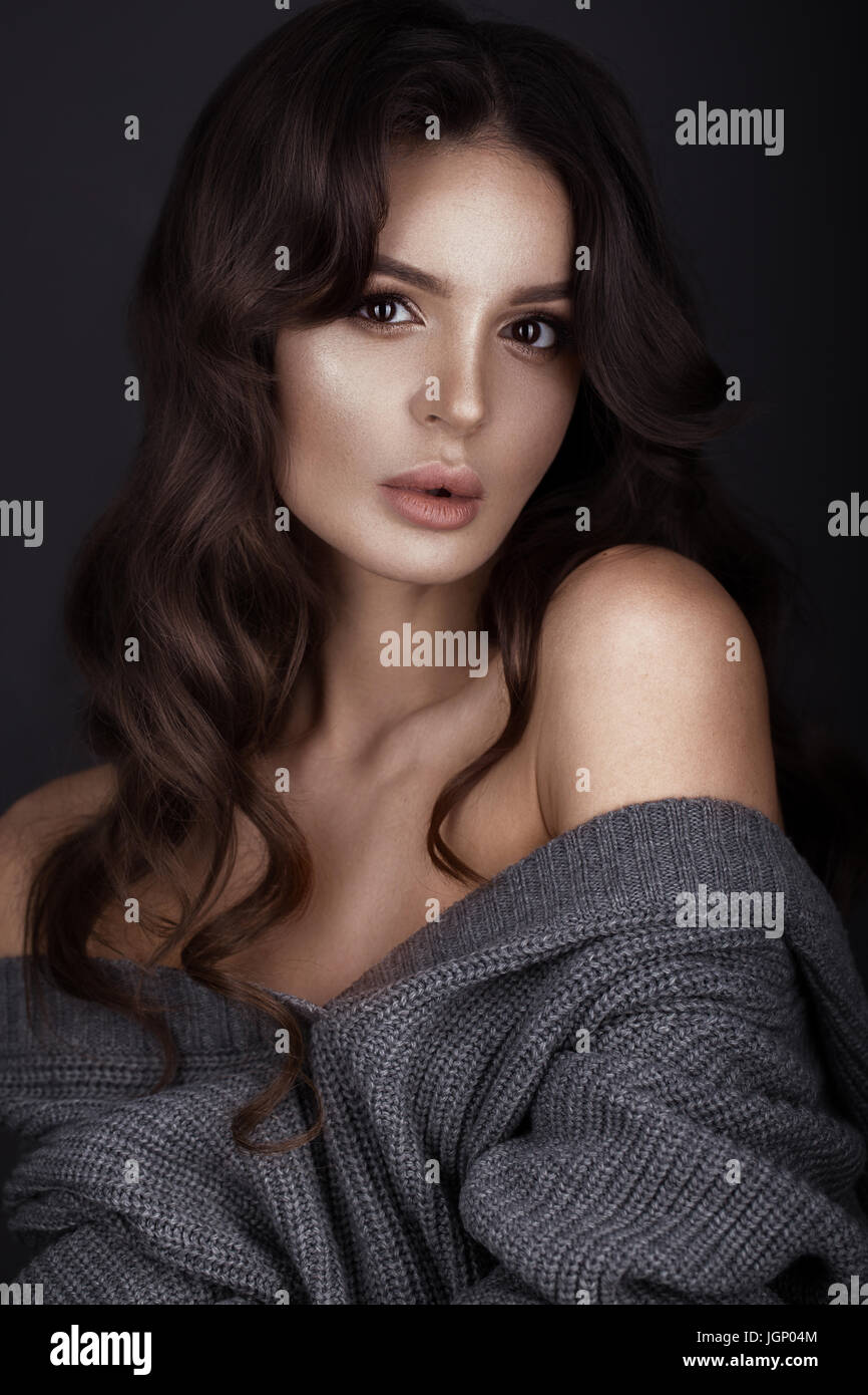 Beautiful woman with healthy skin and hair curls, posing in studio ...