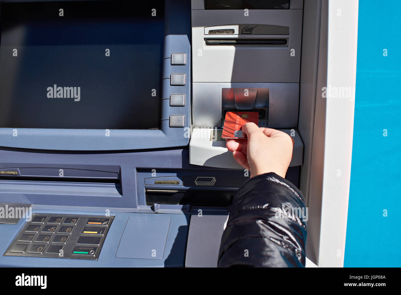 Hand with a bank card at the ATM Stock Photo - Alamy