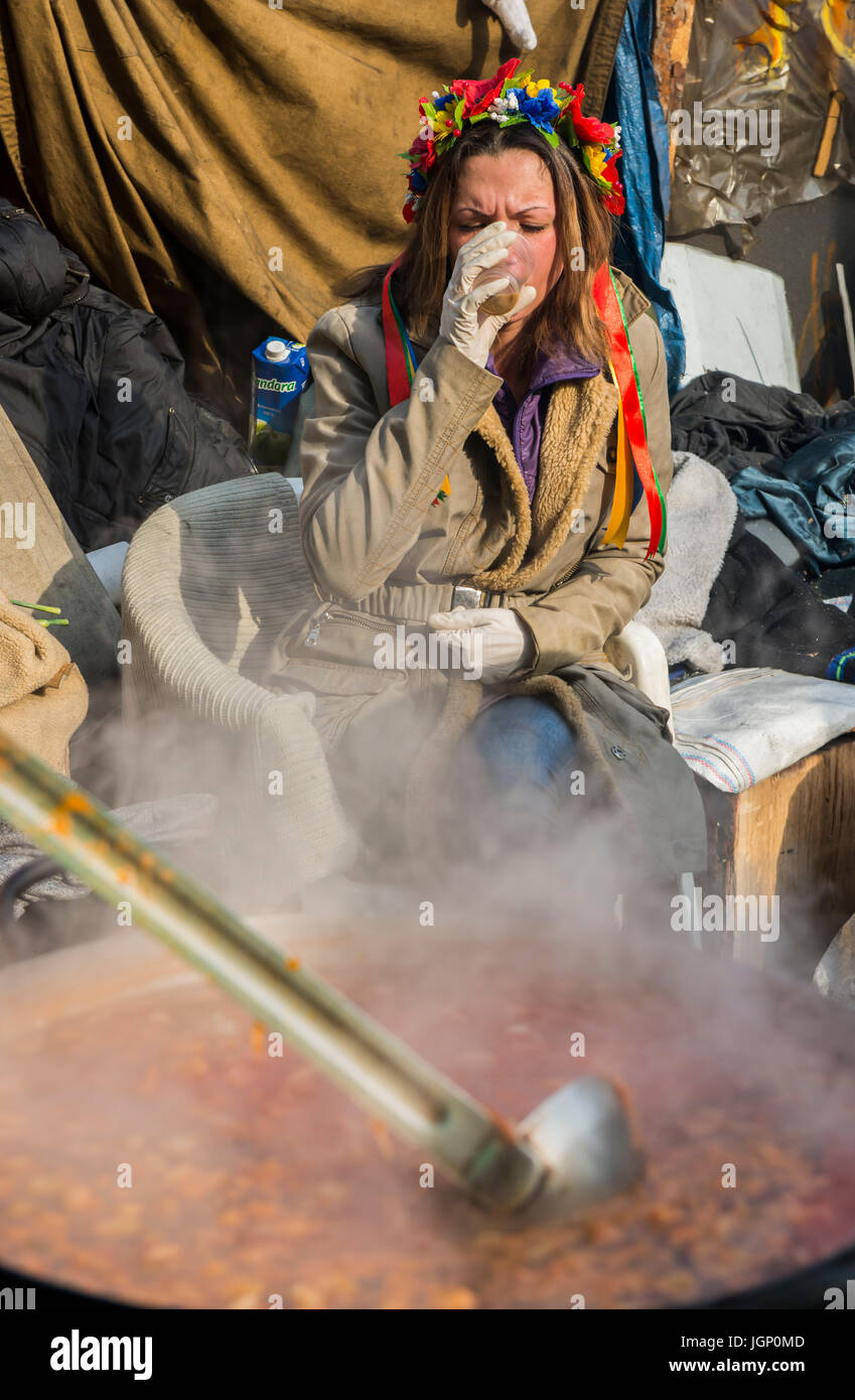 Kiev, Ukraine - February 26, 2014: Woman drinking in Kiev on Maidan ...