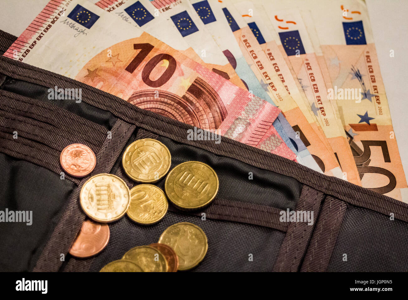 A composition of euro banknotes and coins providing great options to be ...