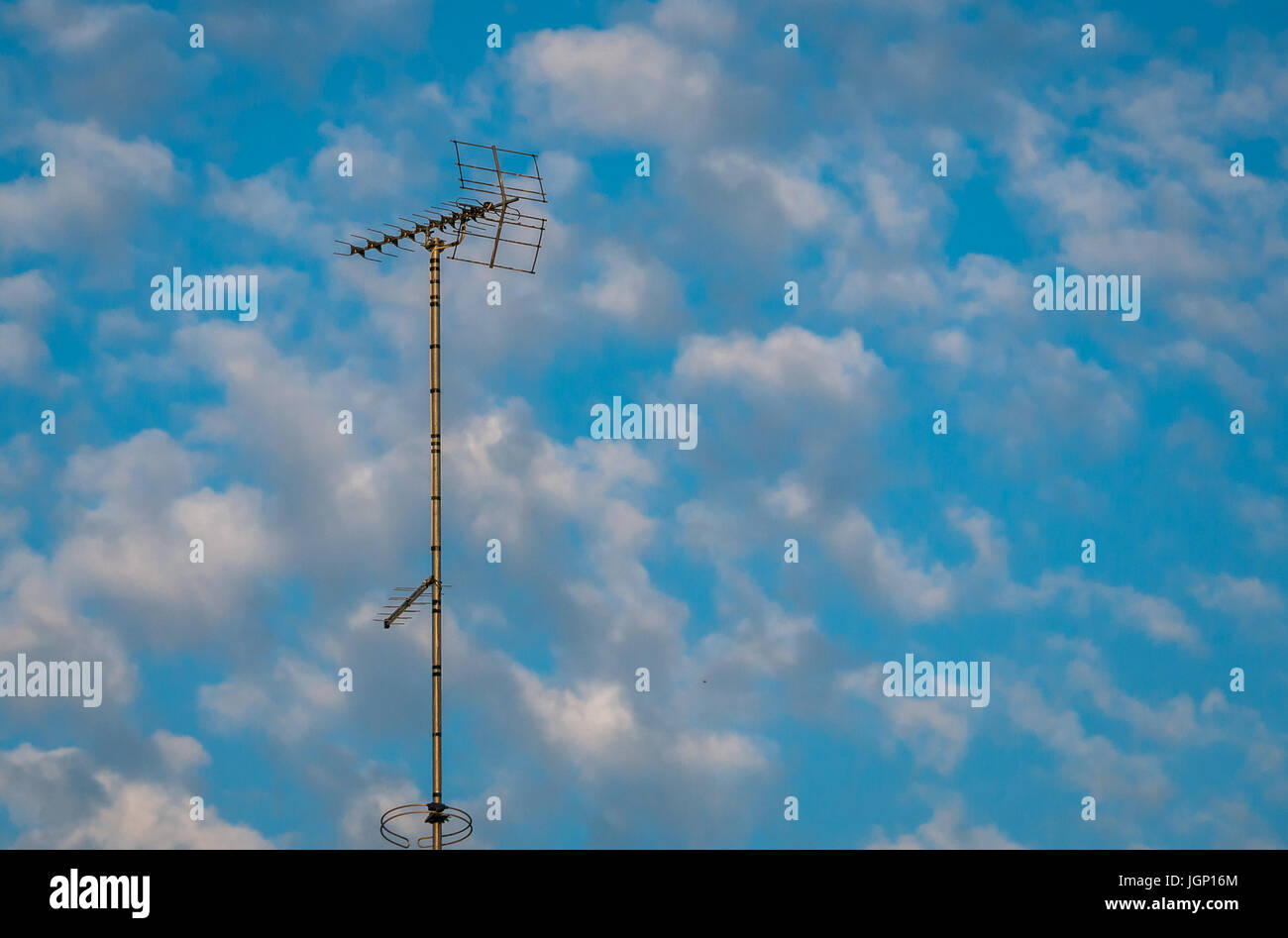 Close up of high rooftop TV aerial against blue sky, London, England ...