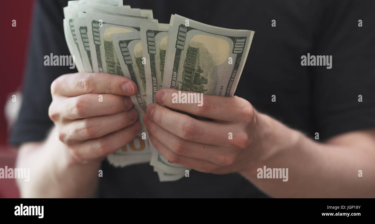 front shot of man counting three thousand dollars Stock Photo - Alamy