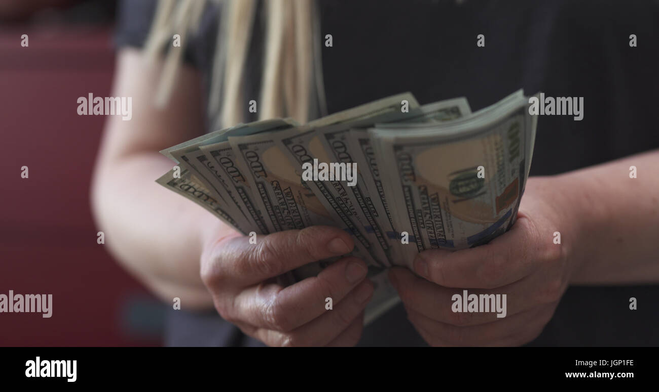 front shot of woman counting dollars Stock Photo - Alamy