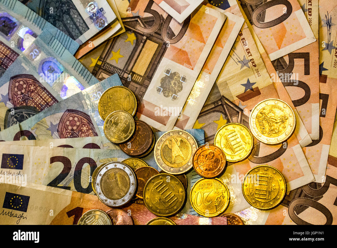 A composition of euro banknotes and coins providing great options to be ...