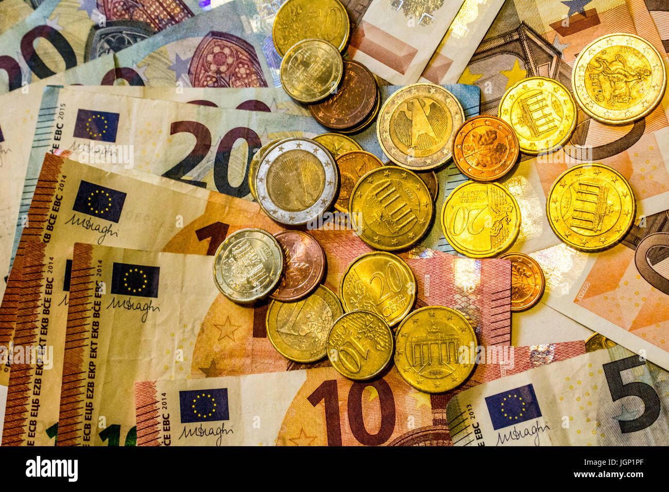 A composition of euro banknotes and coins providing great options to be ...