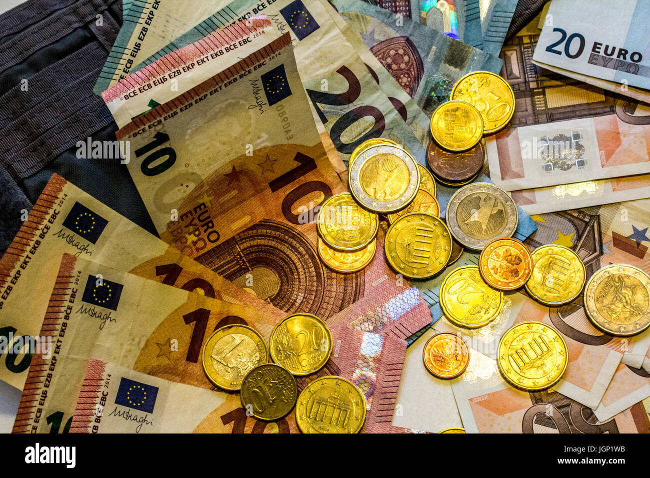 A composition of euro banknotes and coins providing great options to be ...