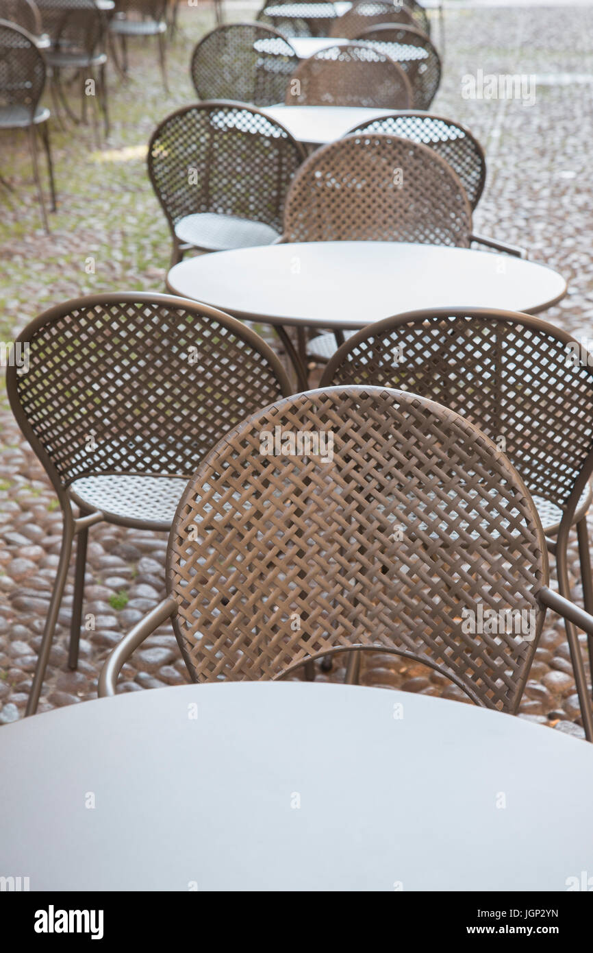 Cafe Table and Chairs on Cobblestone Street, Bologna, Italy Stock Photo - Alamy