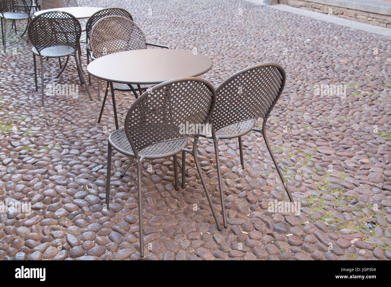 Cafe Table and Chairs on Cobblestone Street, Bologna, Italy Stock Photo ...