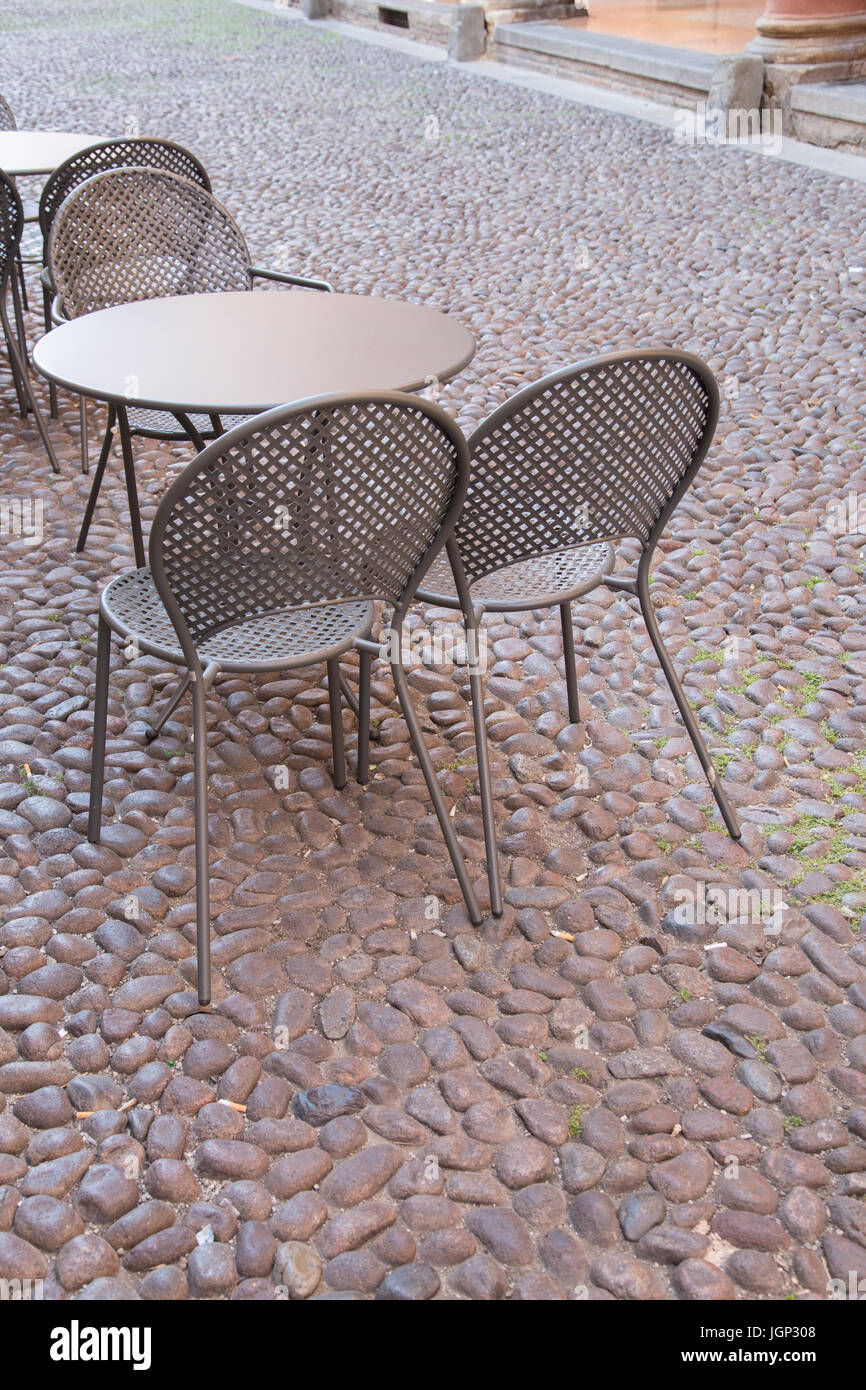 Cafe Table and Chairs on Cobblestone Street, Bologna, Italy Stock Photo - Alamy
