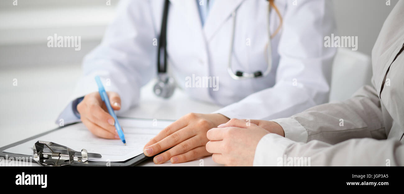 Doctor and patient sitting at the desk. Medicine and health care ...