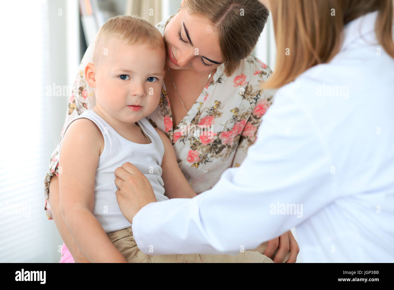 Doctor examining a child patient by stethoscope Stock Photo - Alamy