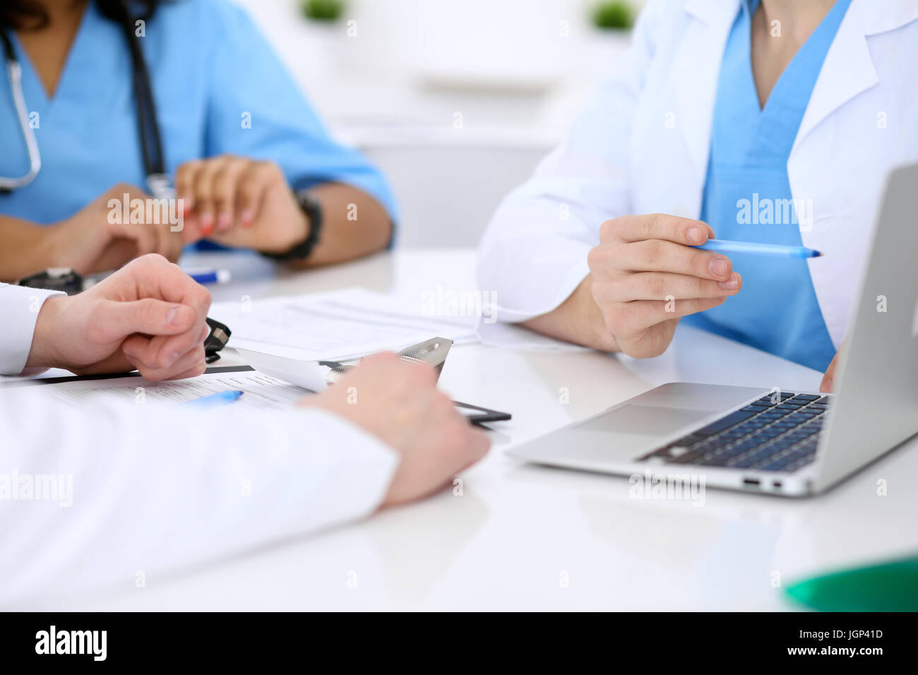 Group of doctors discuss at meeting close-up Stock Photo - Alamy