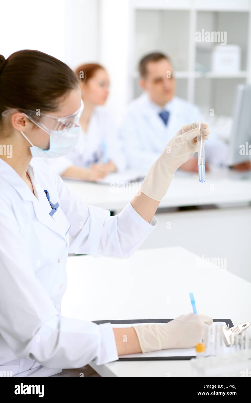 Scientific research team with clear solution in laboratory Stock Photo ...