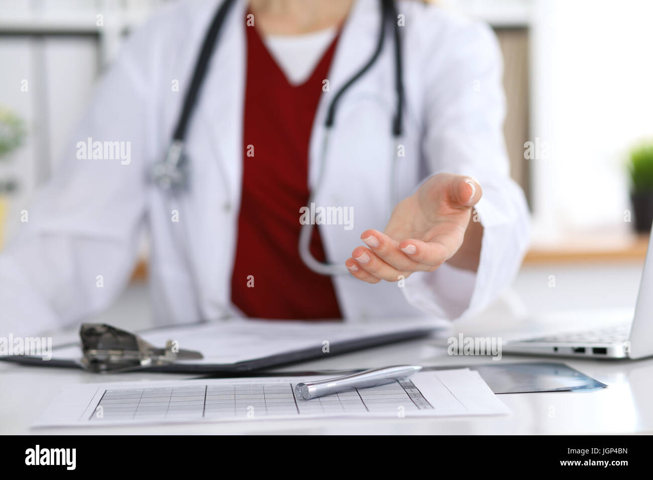 Female medicine doctor offering helping hand in office closeup ...