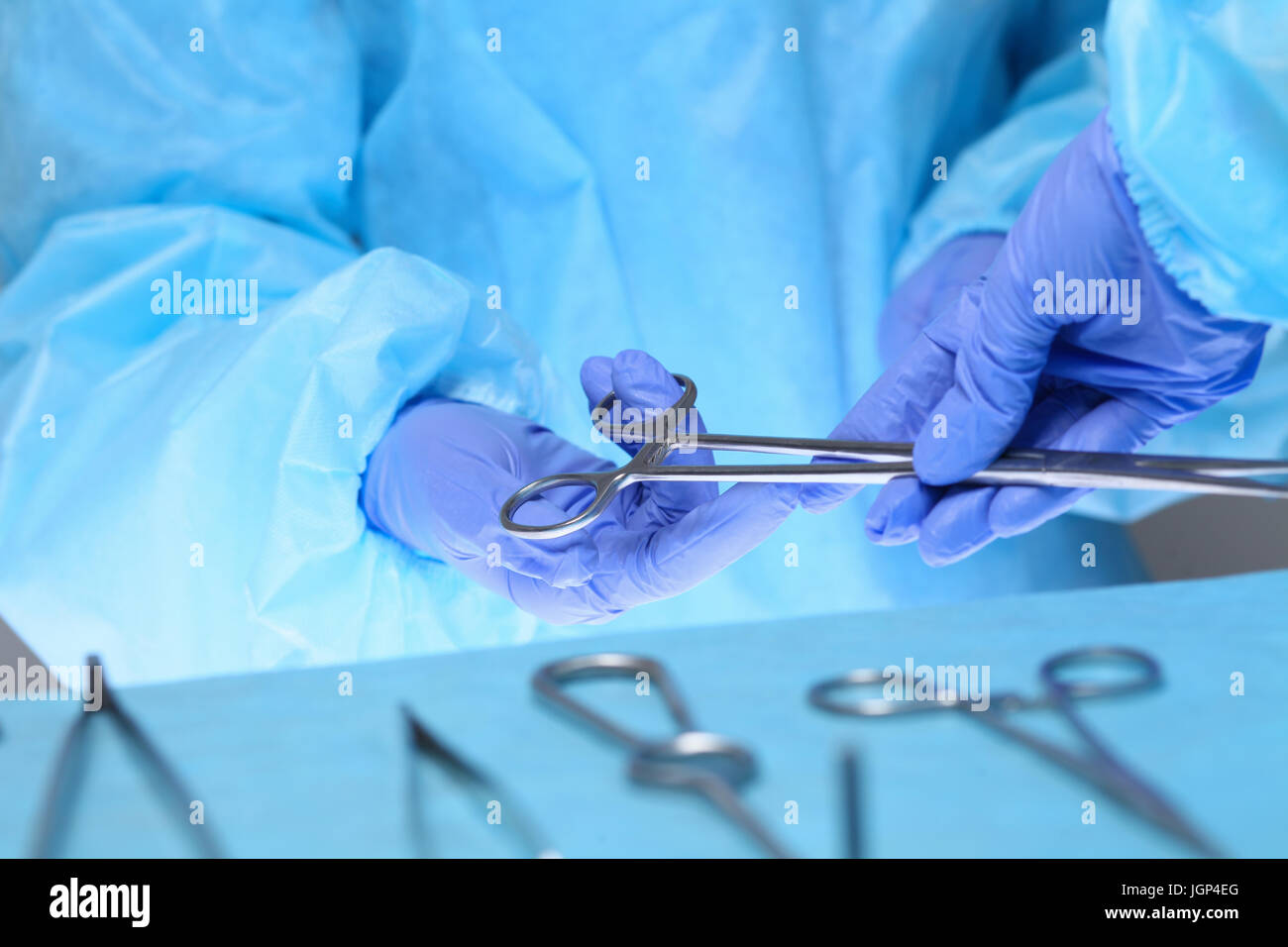 Close-up of of surgeons hands at work in operating theater toned in ...