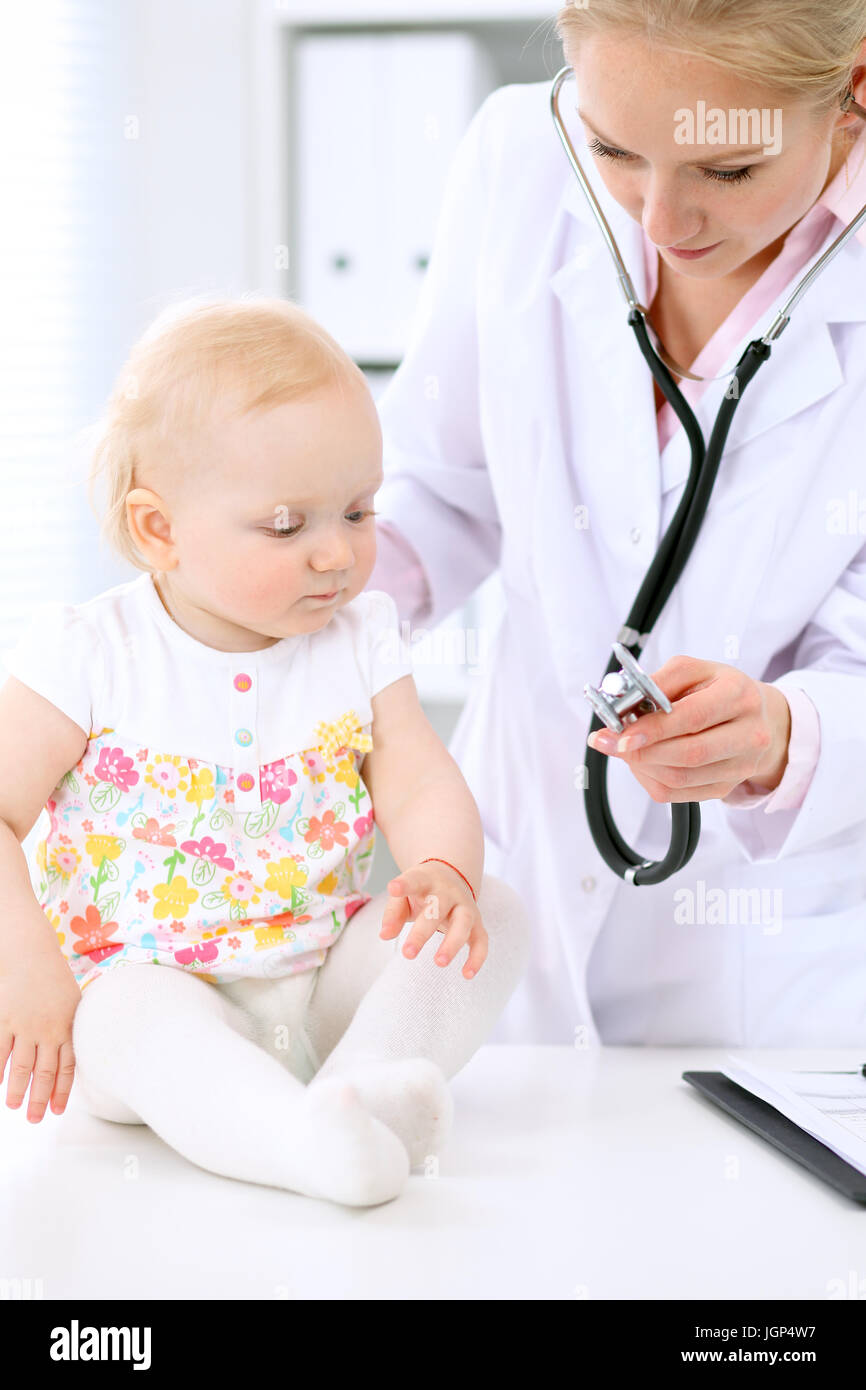 Pediatrician is taking care of baby in hospital. Little girl is being ...