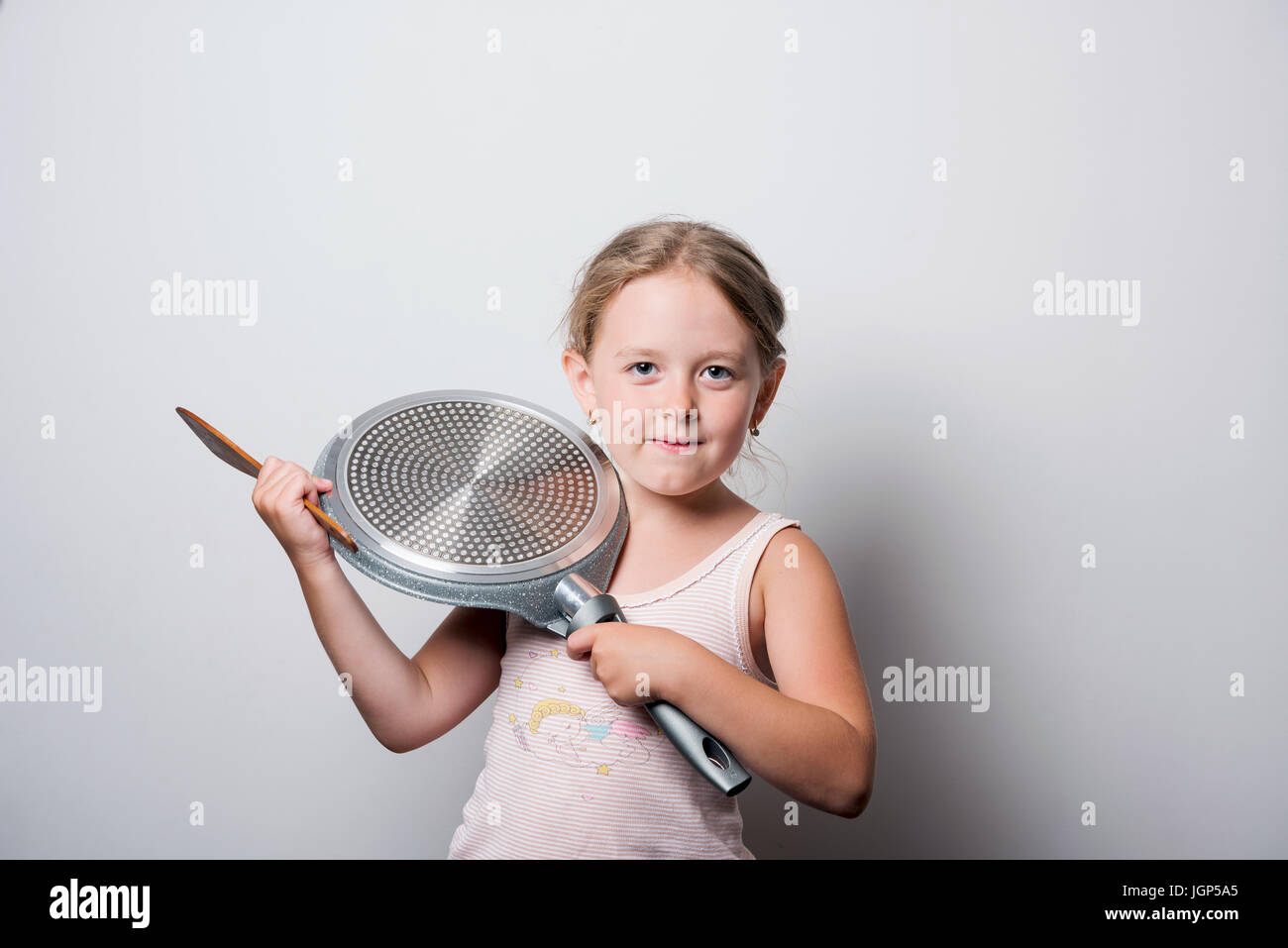 funny little girl with a frying pan Stock Photo - Alamy