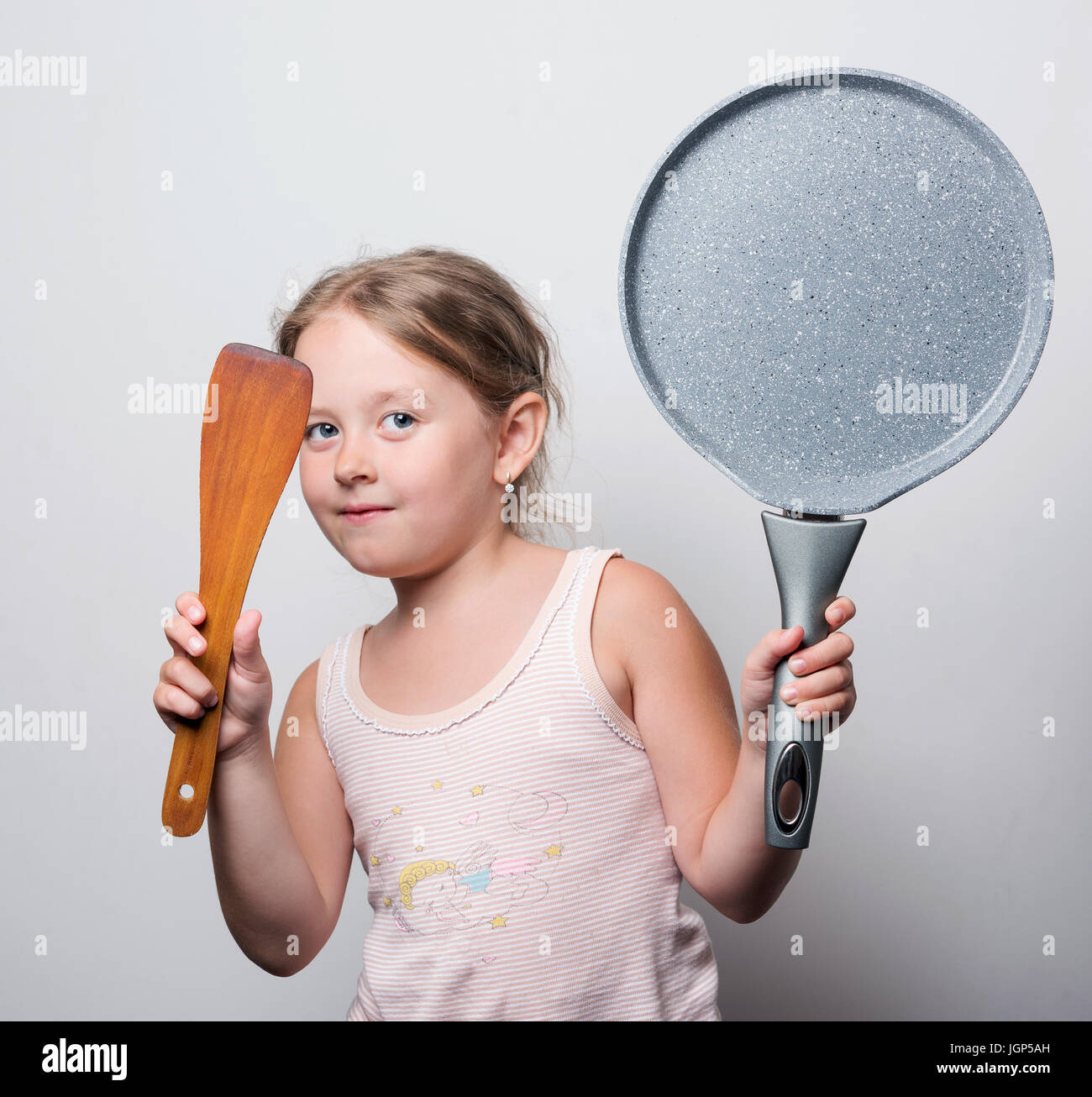 funny little girl with a frying pan Stock Photo - Alamy
