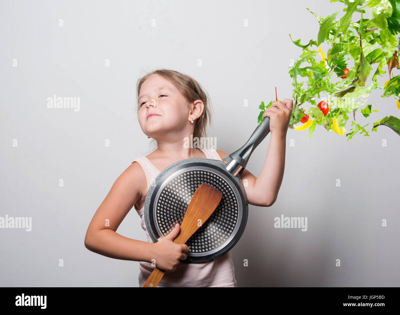 funny little girl with a frying pan Stock Photo - Alamy