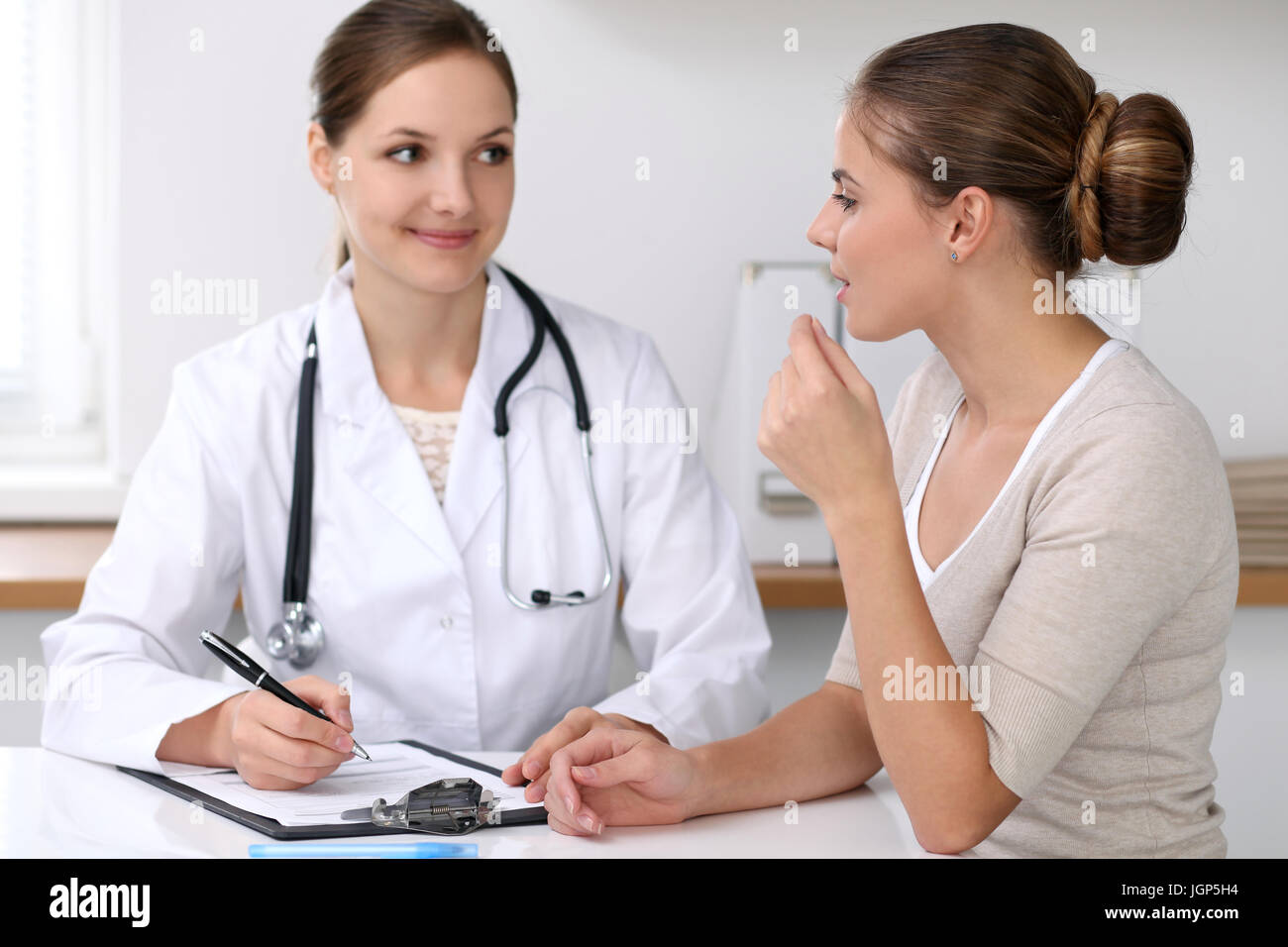Doctor and patient sitting at the desk. Medicine and health care ...
