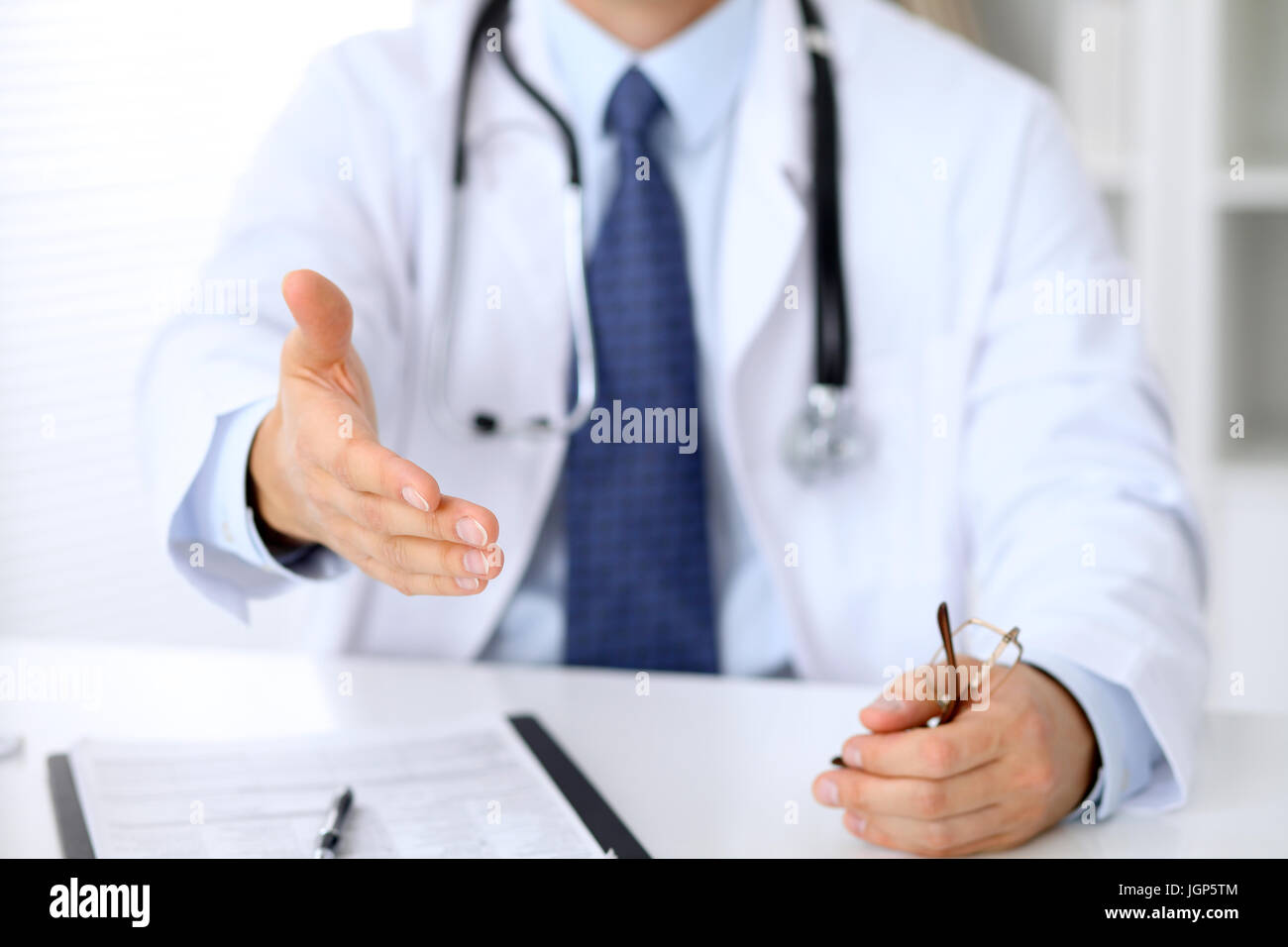 Male medicine doctor offering helping hand for handshake. Partnership ...