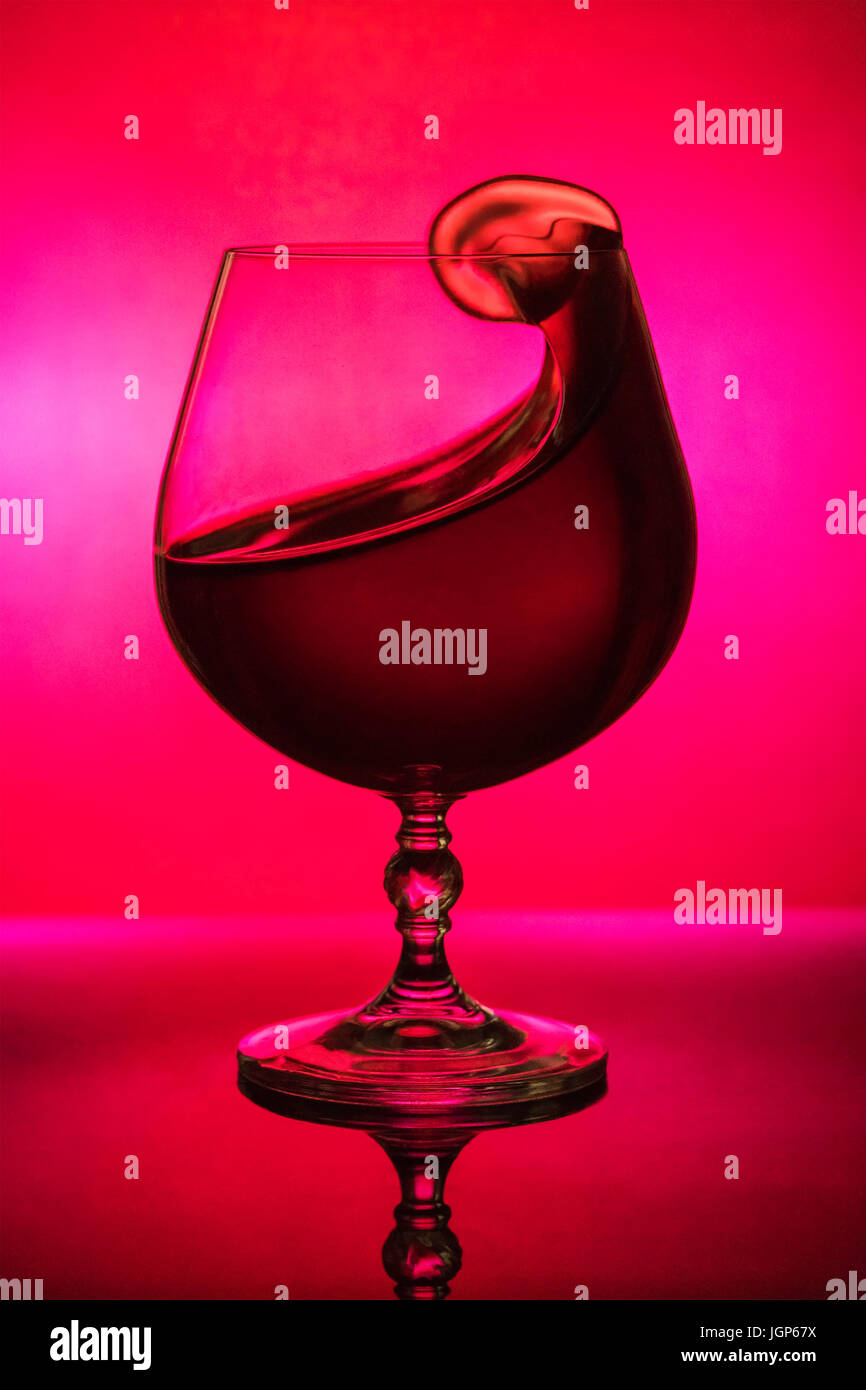 Splash of wine in a glass Stock Photo - Alamy