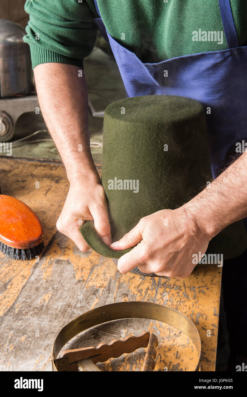 Man fitting wet hat body to wooden form, hatmaker workshop, Bad Aussee ...
