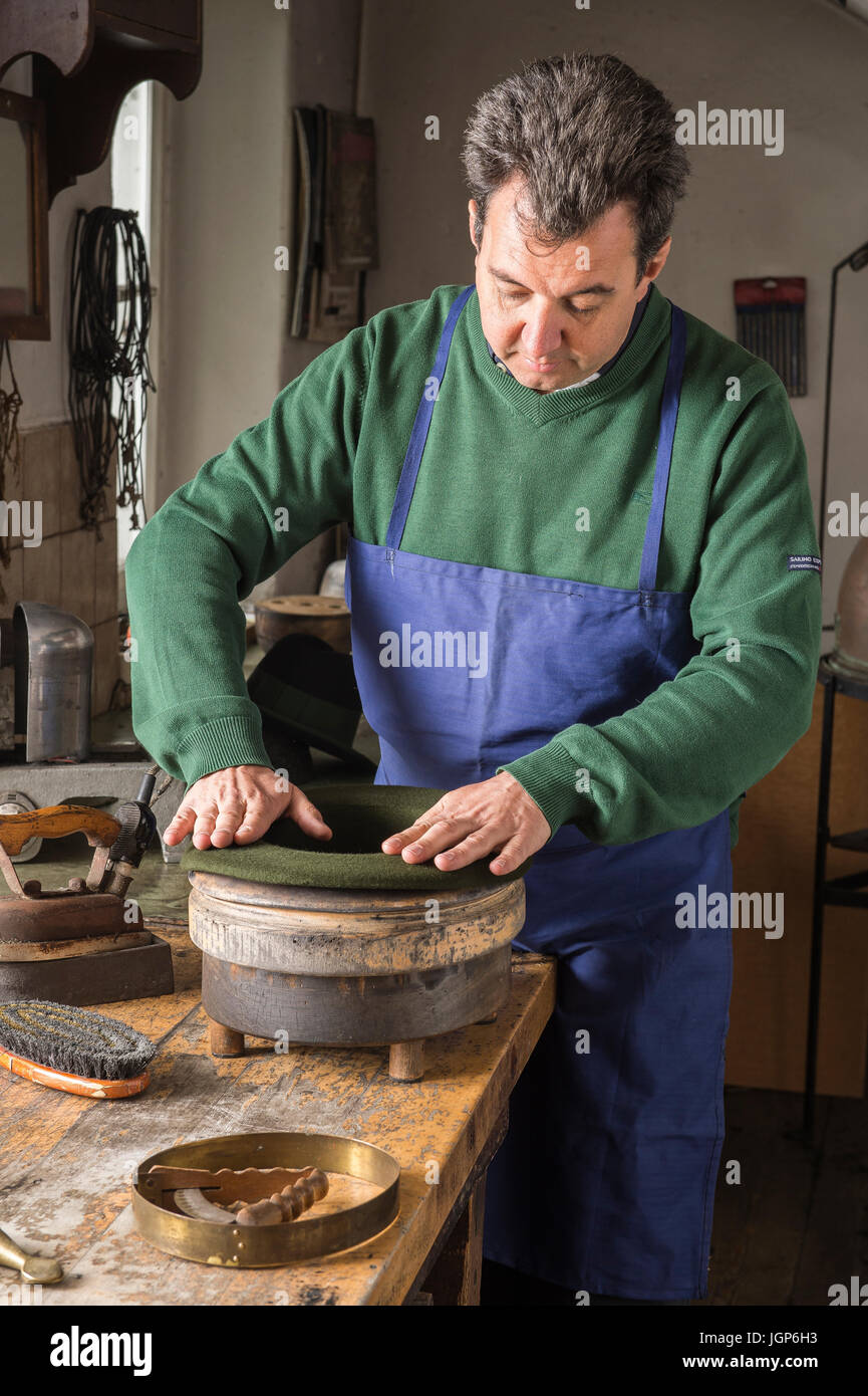 Hatter pushing dry wool felt hat into edge mold, hatmaker workshop, Bad ...