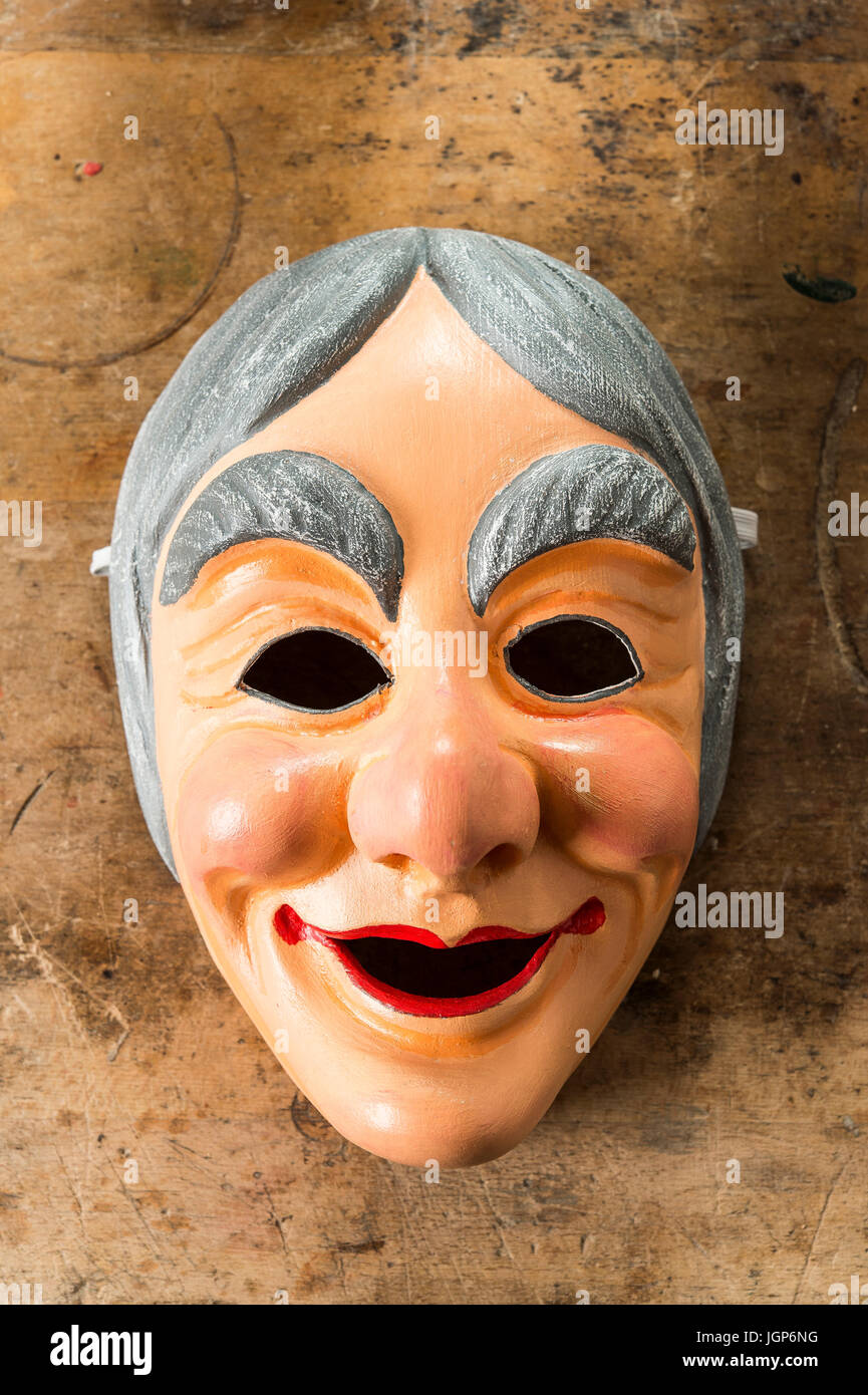 Painted wooden mask on a workbench, wooden mask carver, Bad Aussee ...