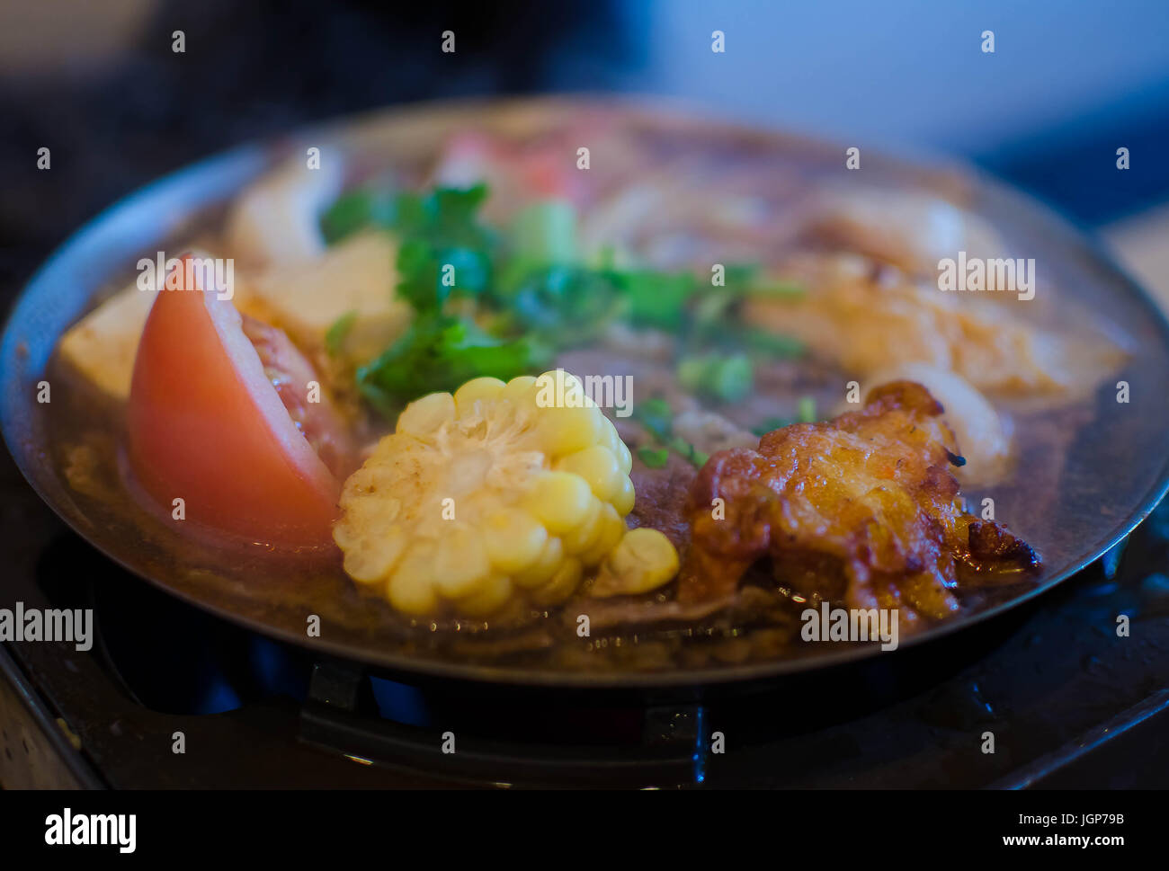 Hot pot full with corn and tomato Stock Photo - Alamy