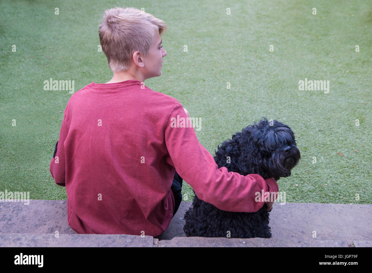 A boy hugs his pet dog Stock Photo - Alamy