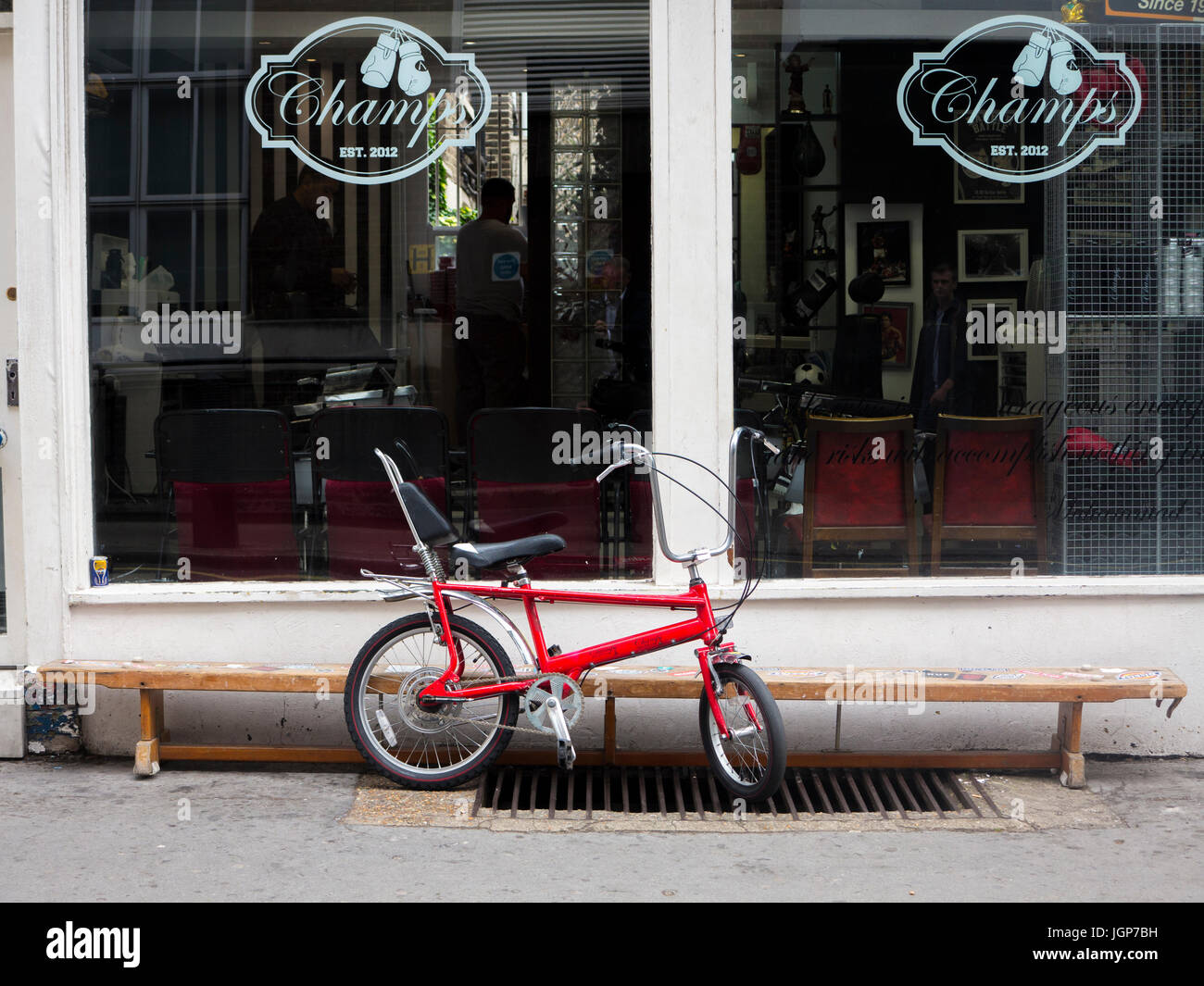 A 1970's chopper bike outside a barber's shop in London Stock Photo - Alamy
