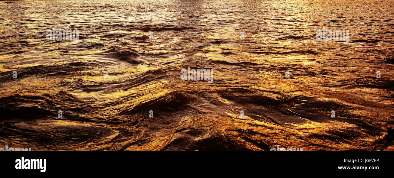 Gold reflection on the calm ocean Stock Photo - Alamy