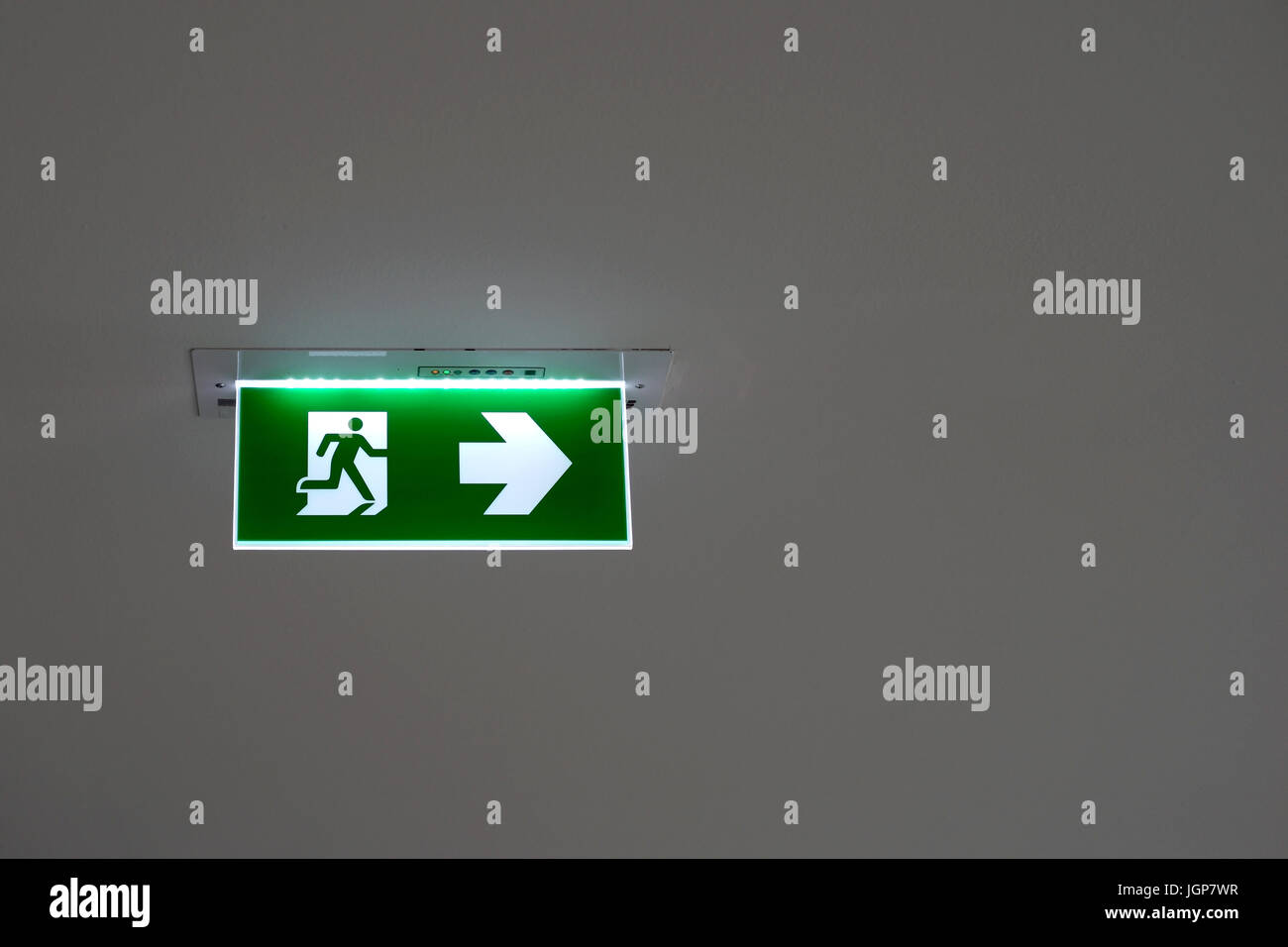 green emergency exit sign on the ceiling Stock Photo - Alamy