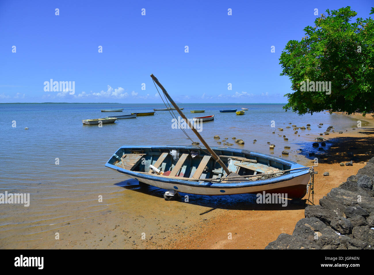 Seascape at sunny day in summer - a wooden boat on the beach with many ...
