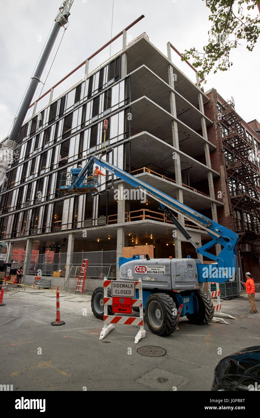 cherry picker elevated platform guiding building panels on construction ...