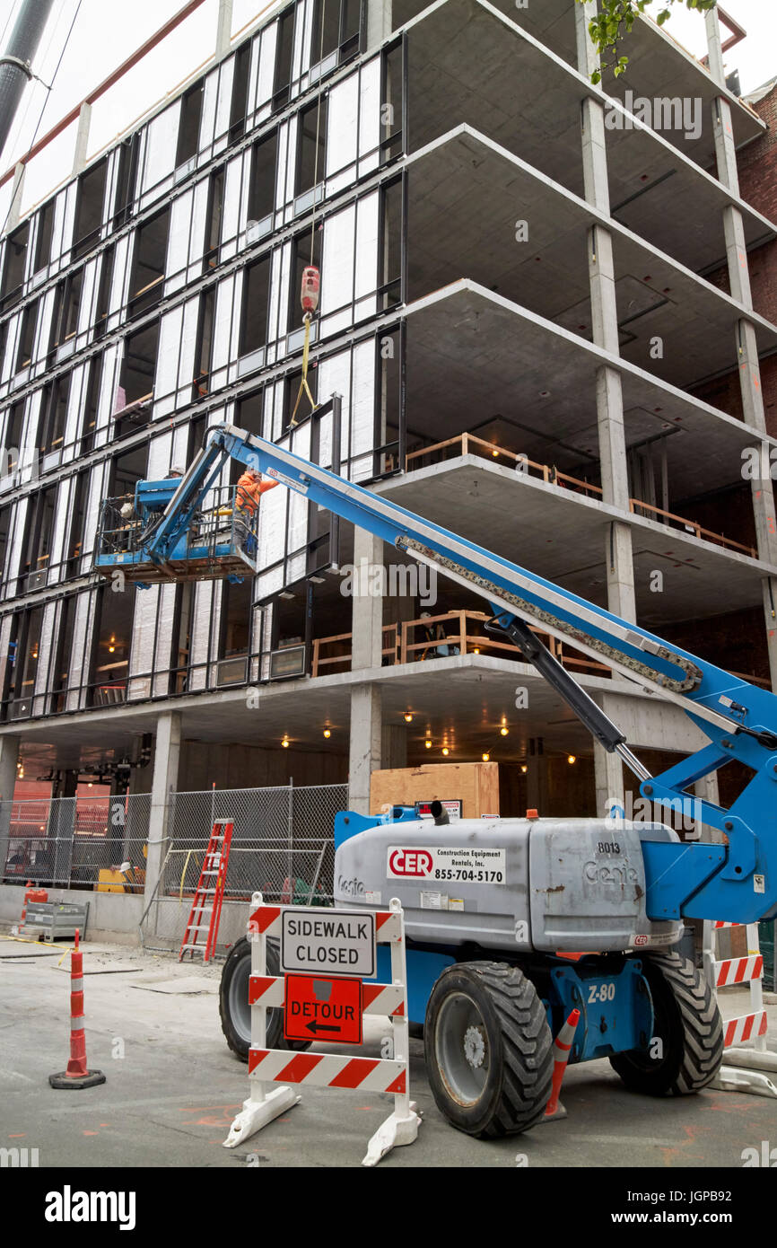 cherry picker elevated platform guiding building panels on construction ...