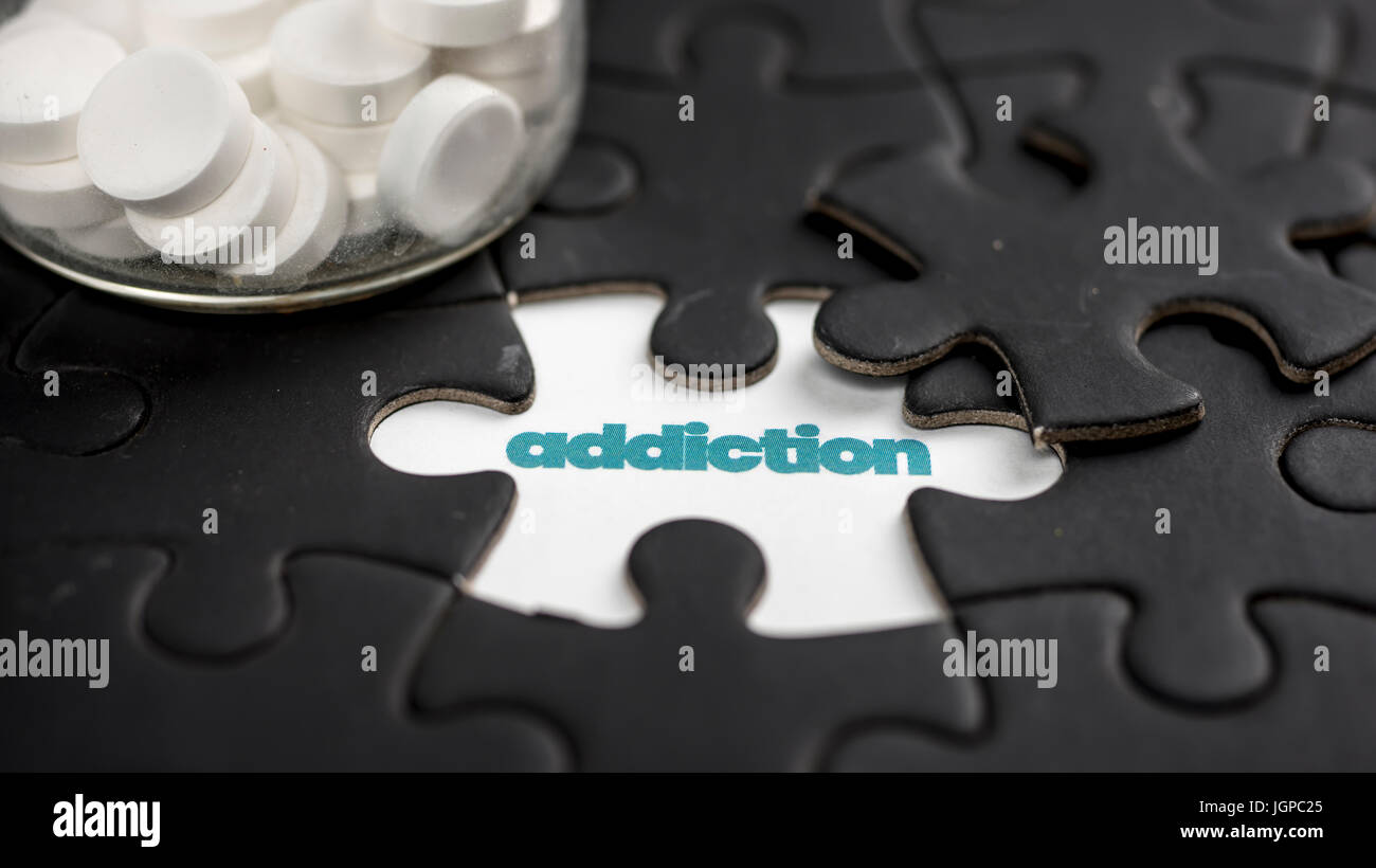Word addiction under jigsaw puzzle piece Stock Photo - Alamy