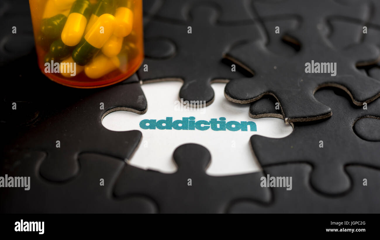 Word addiction under jigsaw puzzle piece Stock Photo - Alamy