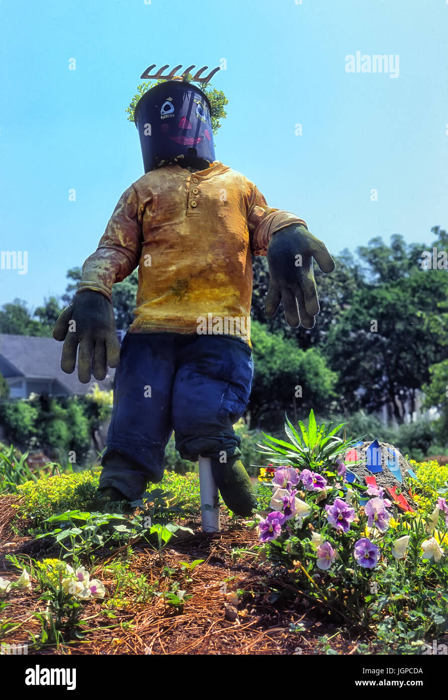 Scare crow in garden, colorful Stock Photo - Alamy