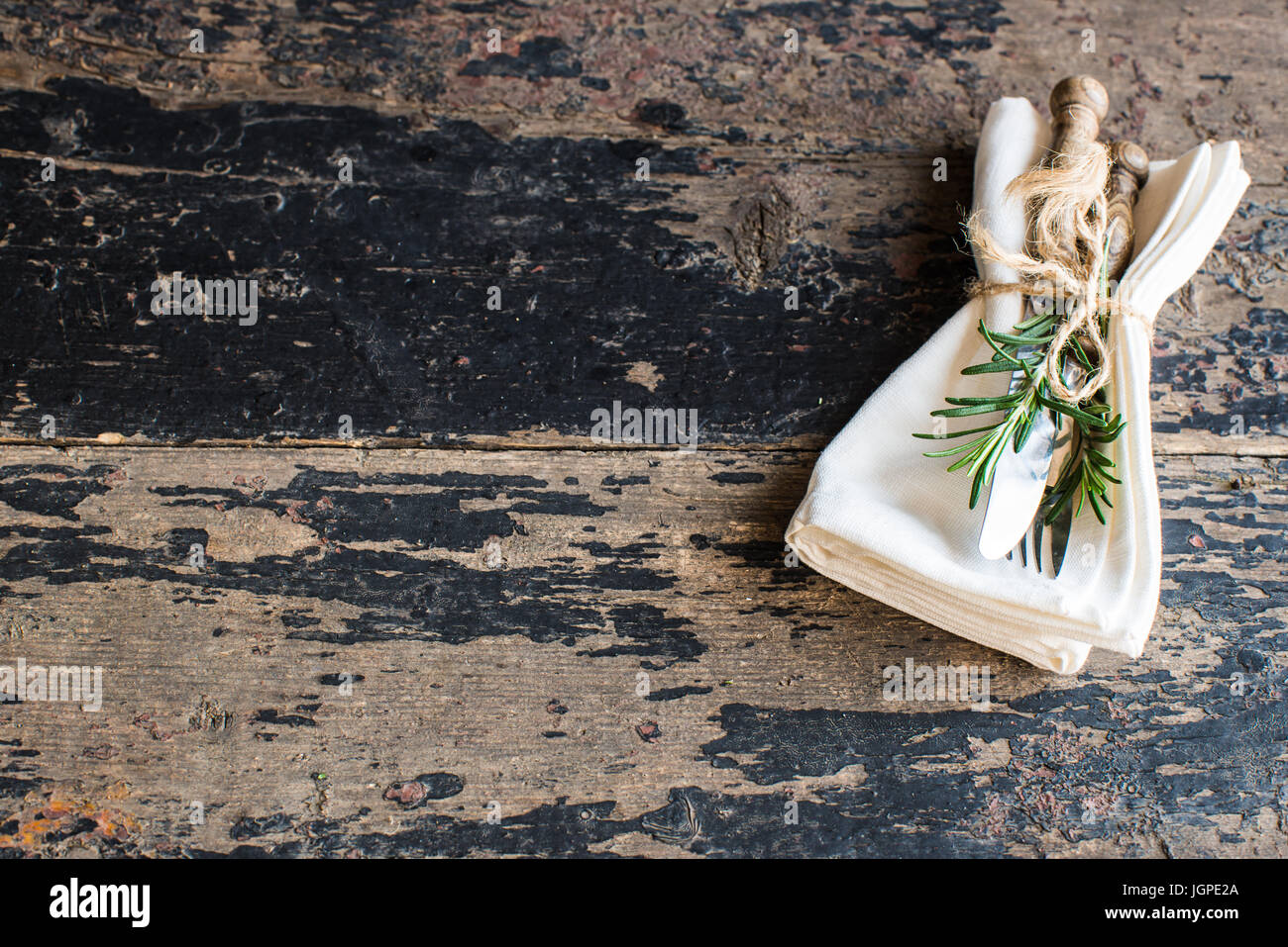 Table setting with fresh rosemary and rustic silverware on dark wooden table Stock Photo - Alamy